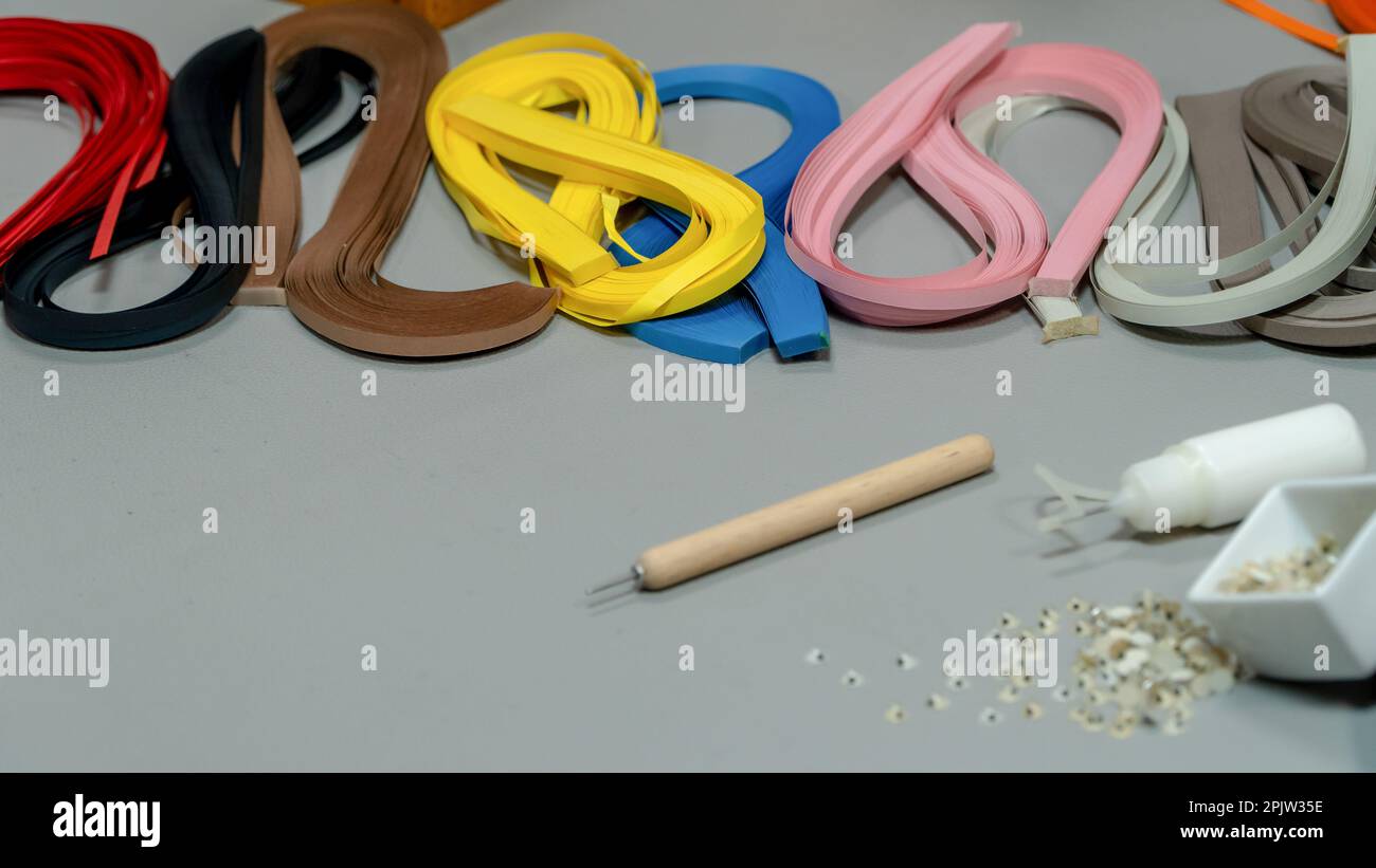 Colored paper quilling stripes for craft making on a white background ...
