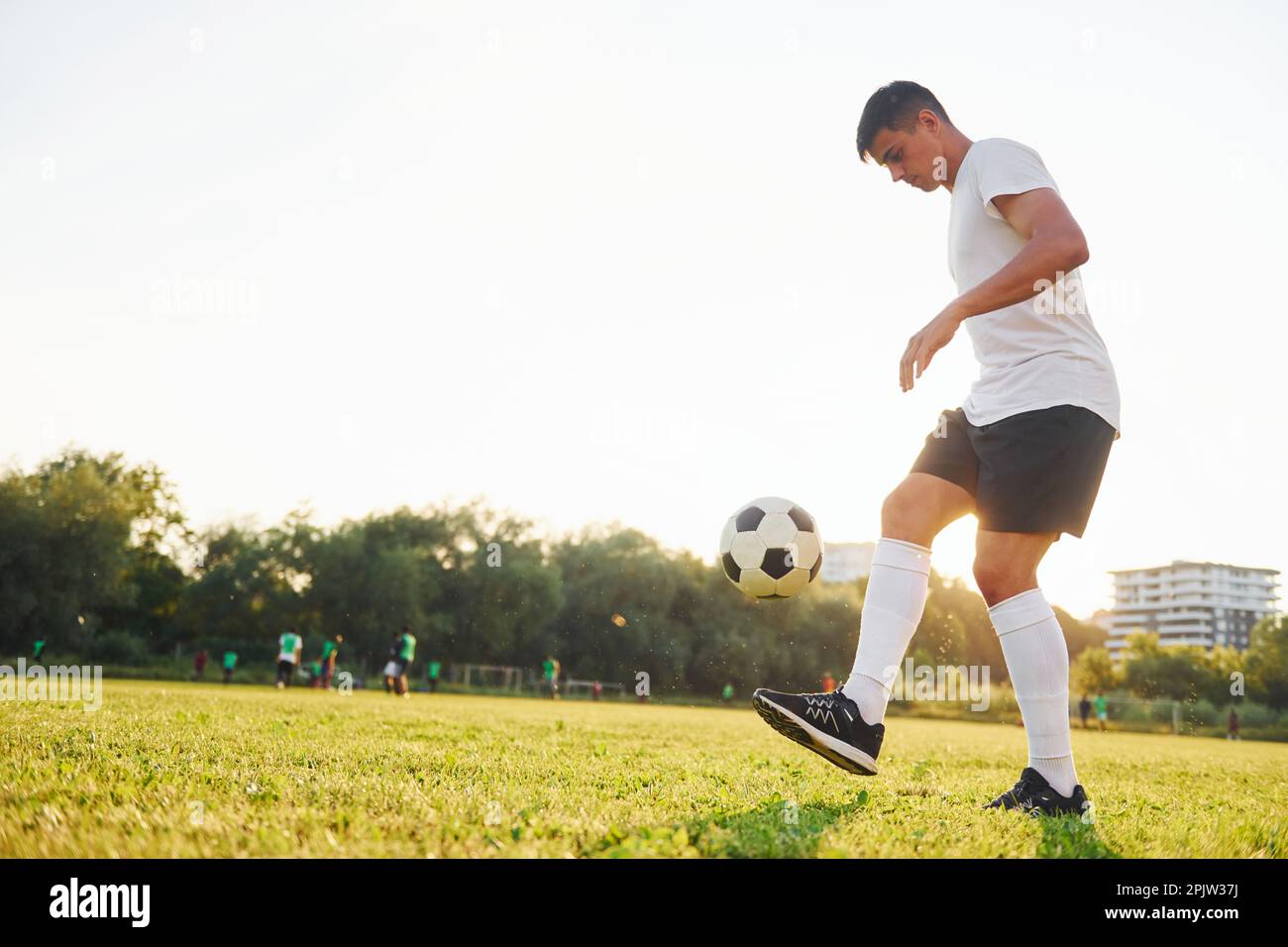 Doing different tricks. Young soccer player have training on the ...