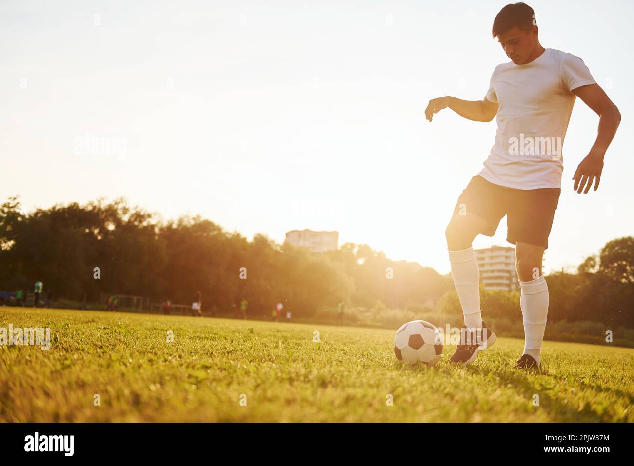 Doing different tricks. Young soccer player have training on the ...