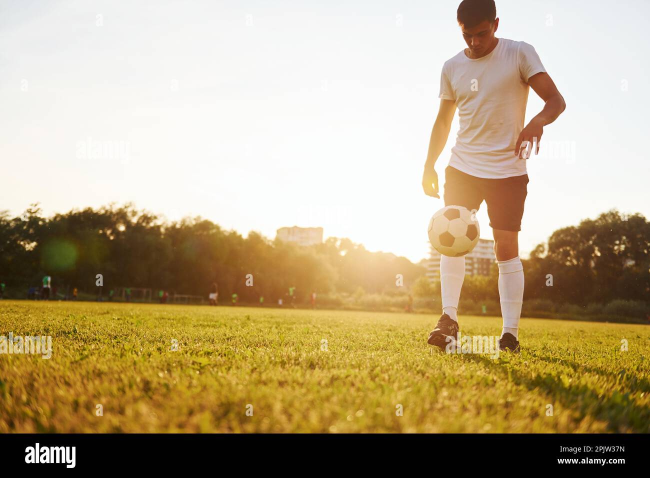 Doing different tricks. Young soccer player have training on the ...