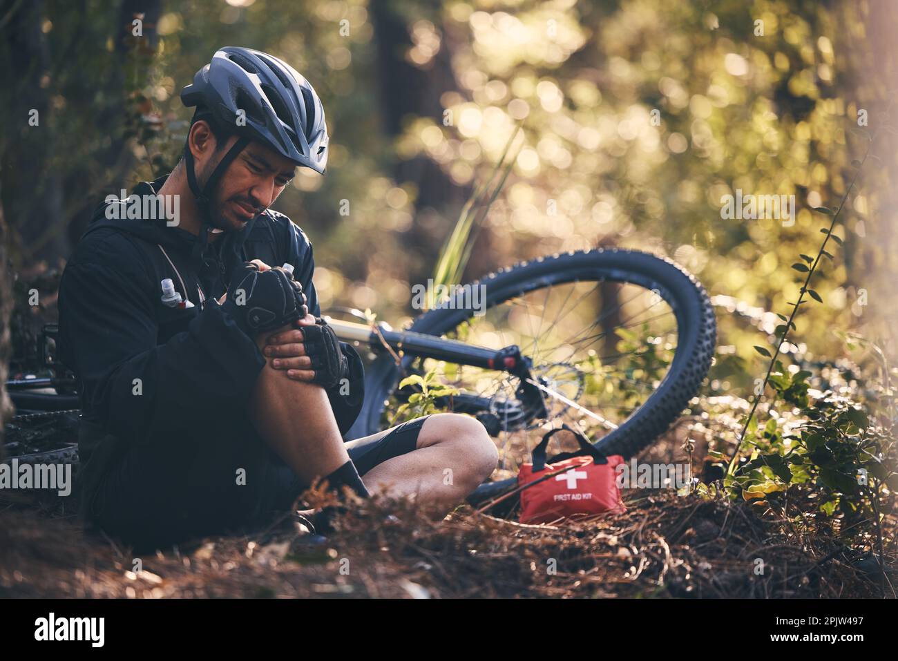 Sports man, injury and first aid outdoor while cycling on mountain bike ...
