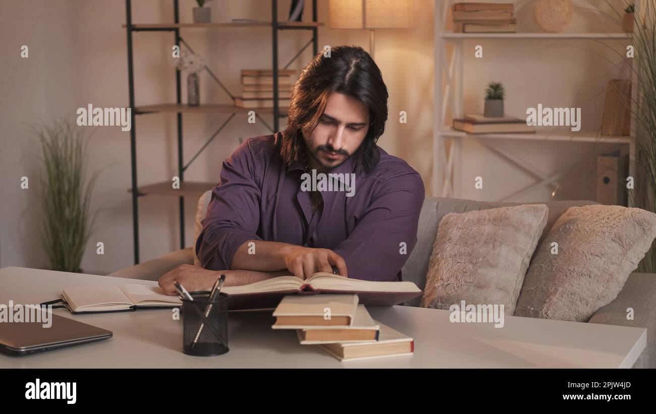 Book research home study guy learning reading exam Stock Photo - Alamy