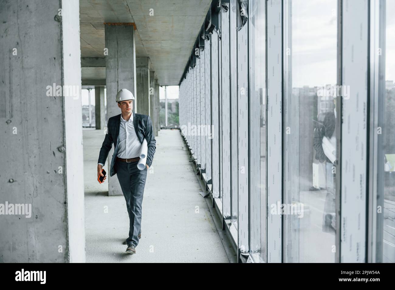 Businessman inside the building. Young man in formal wear is working ...
