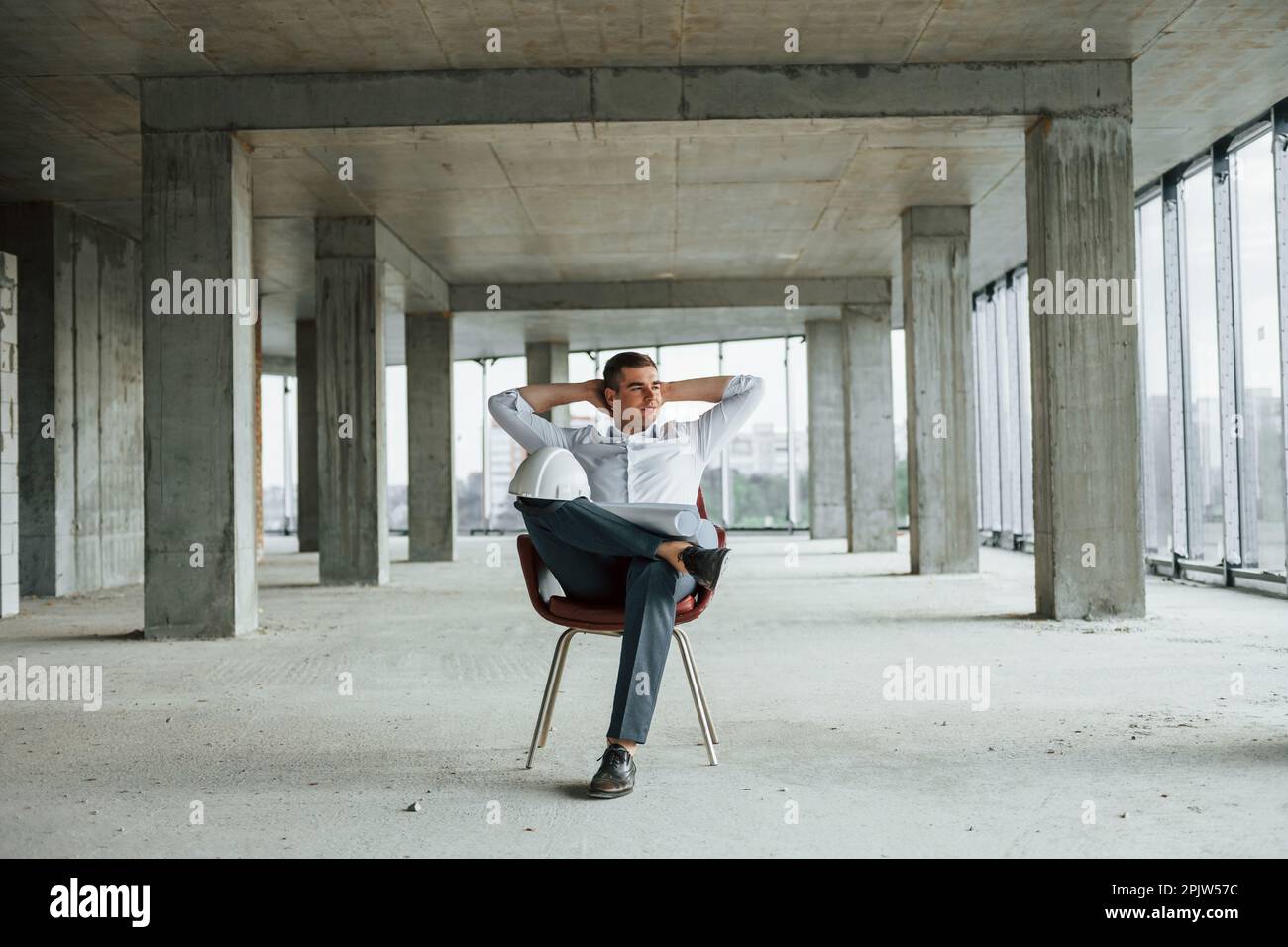 Businessman inside the building. Young man in formal wear is working ...