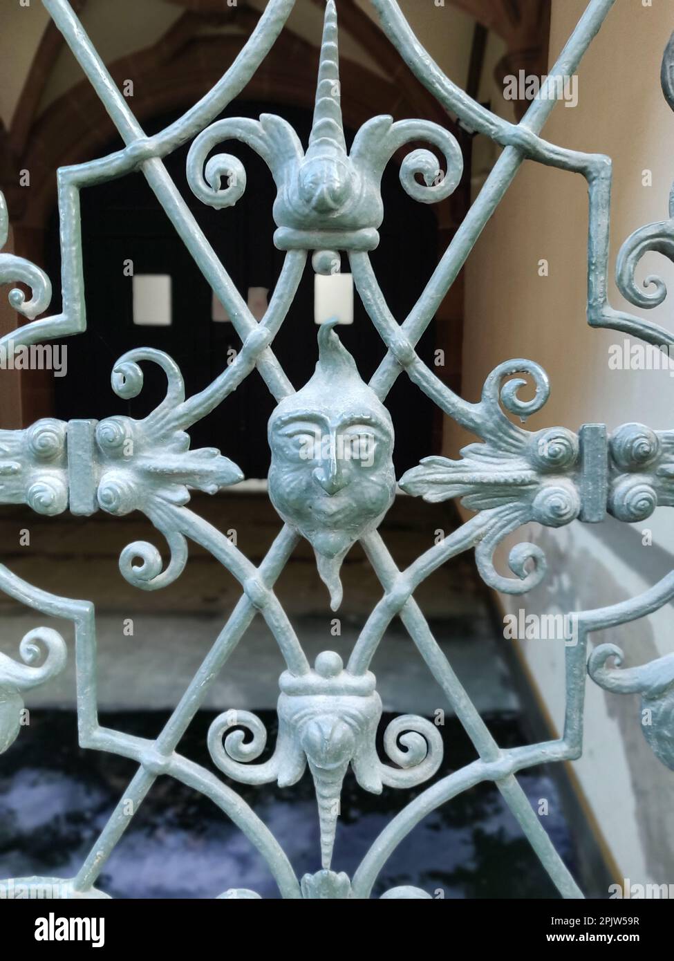 Intricately designed wrought iron fence with ornamental figures ...