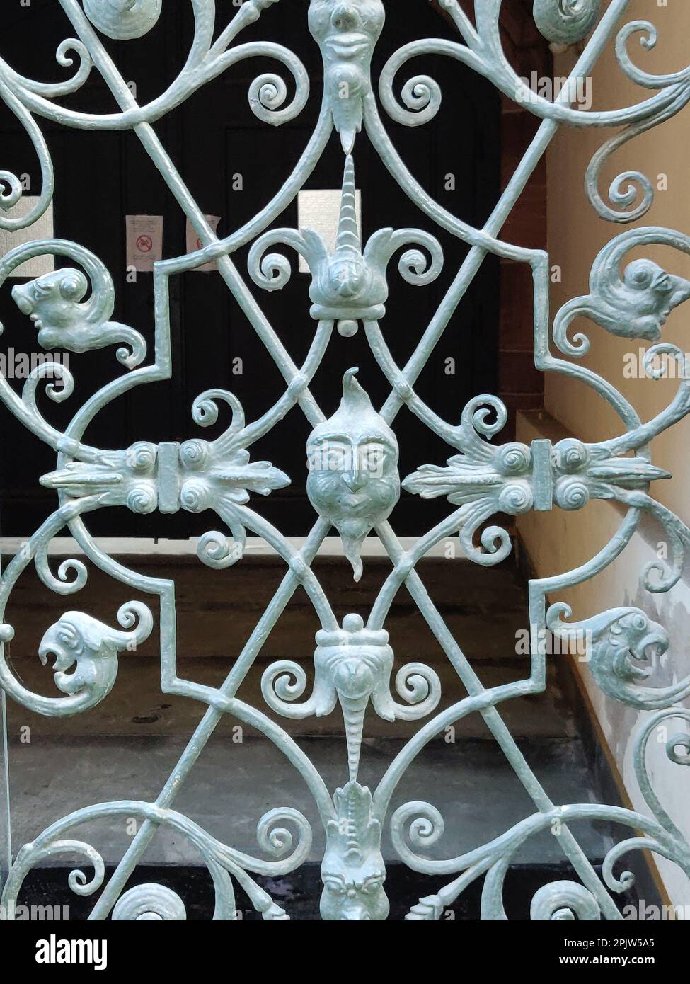 This elegant wrought iron fence features ornamental figures along its ...