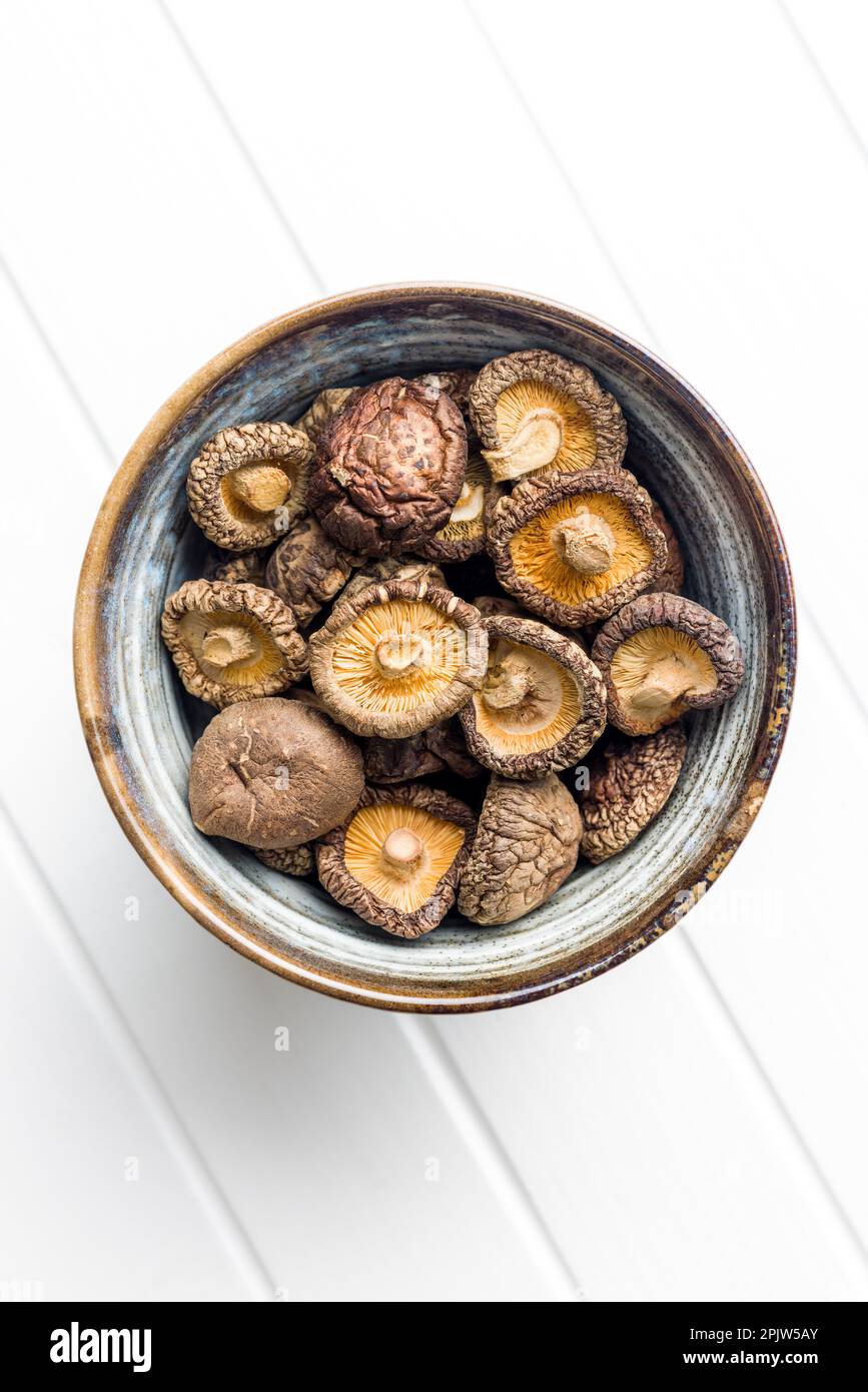 Dried shiitake mushrooms in a bowl. Top view Stock Photo - Alamy