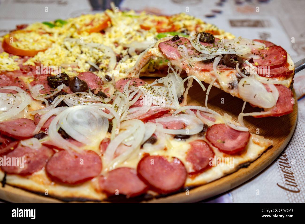 Traditional Brazilian pizza half Portuguese and half Calabrian Stock ...