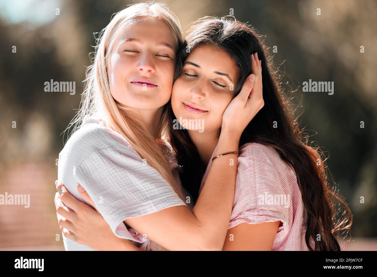 Hug, happy and women with comfort and embrace in nature for bonding ...