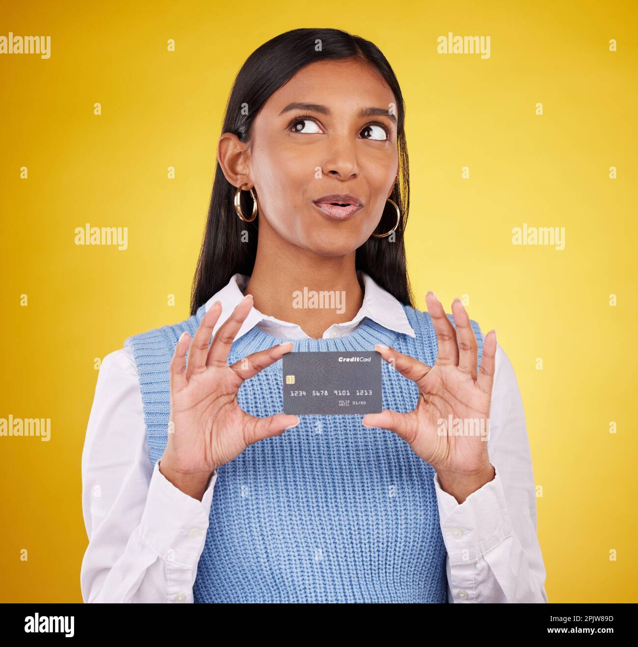 Credit card, thinking and Indian woman on yellow background for bank ...