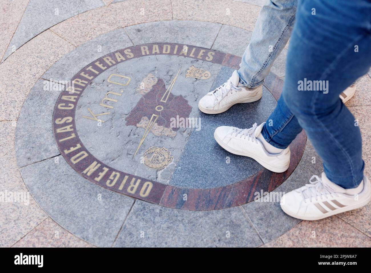 Two people step on the Kilometer Zero plaque on April 4, in Madrid ...