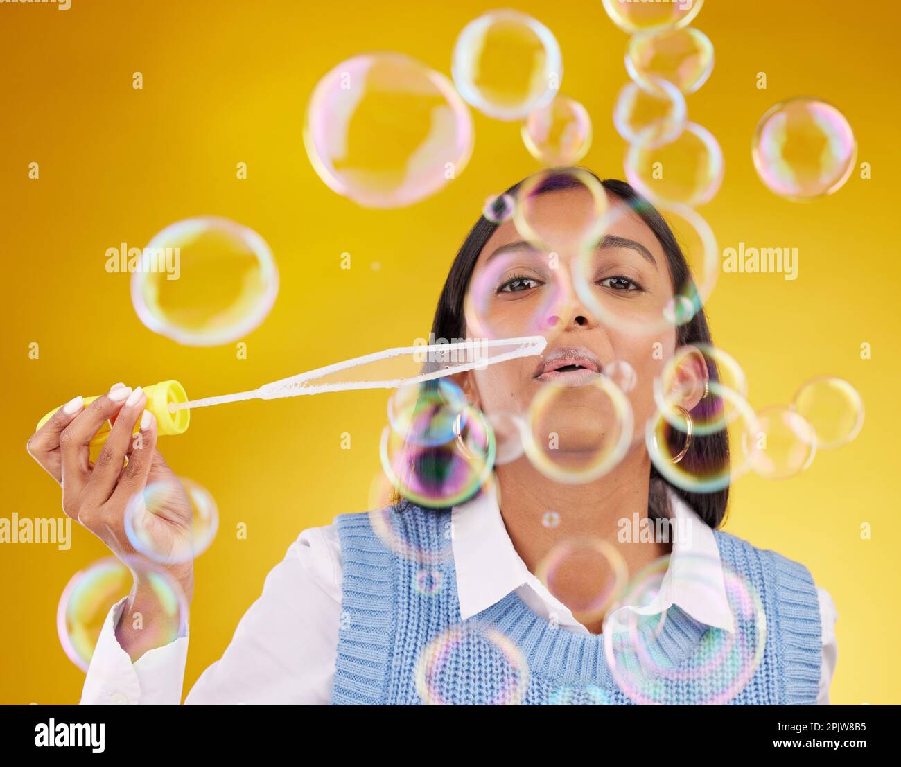 Portrait, fun and woman blowing bubbles, positive attitude and cheerful ...