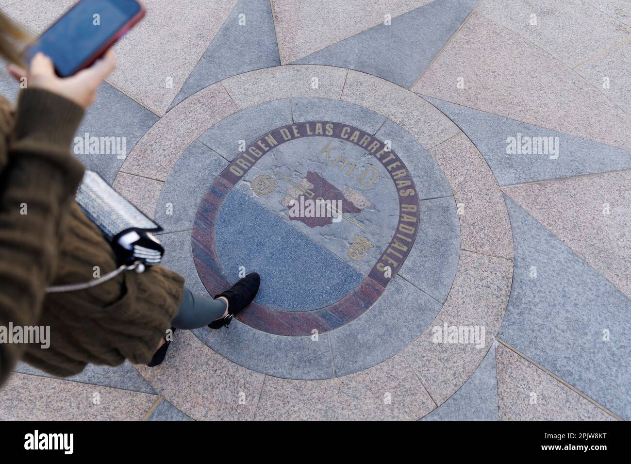 A woman steps on the Kilometer Zero plaque on April 4, in Madrid (Spain ...