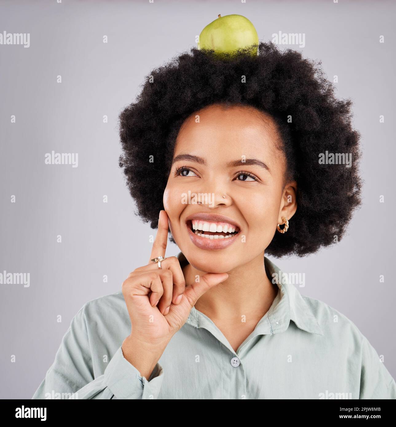 Thinking, apple on head and black woman with happiness, wellness and ...