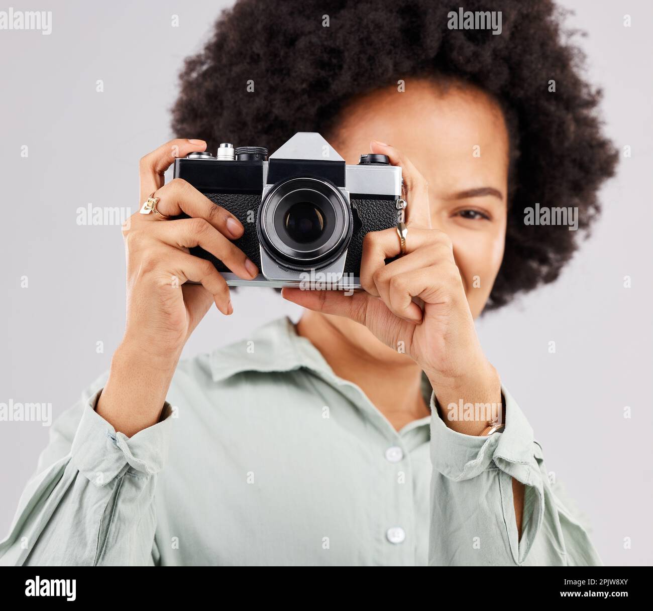 Portrait, camera photographer and black woman in studio isolated on a ...