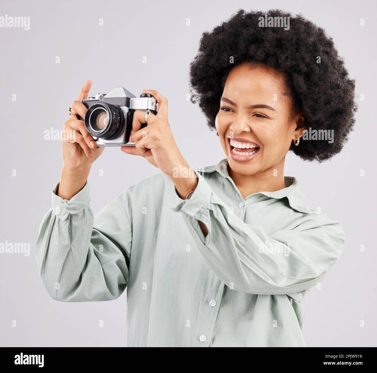 Laughing, camera photographer and black woman in studio isolated on a ...