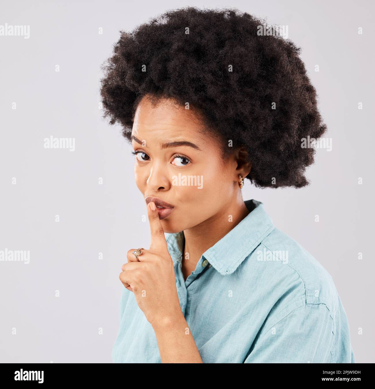 Privacy, portrait and woman with finger on lips in studio, white ...
