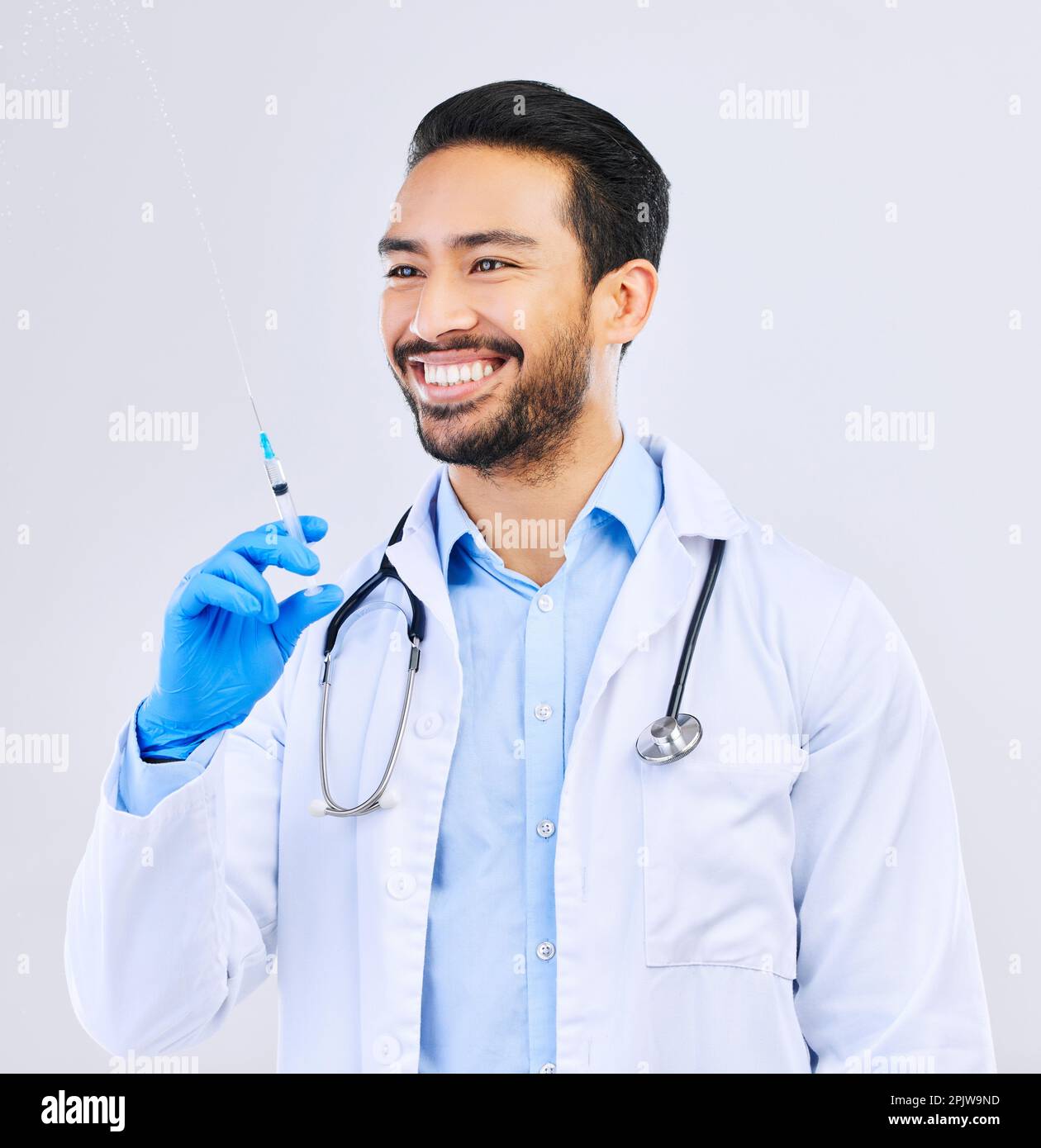 Doctor with smile, syringe and vaccine in studio for healthcare ...