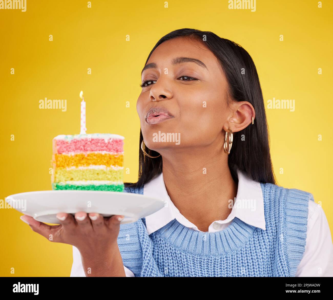 Birthday, cake and woman blowing candle in studio for happy party ...