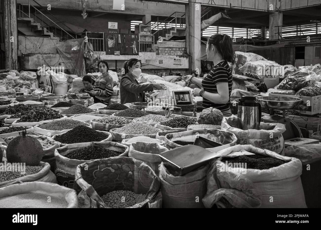 A stallholder completes a transaction with a customer at her stall ...