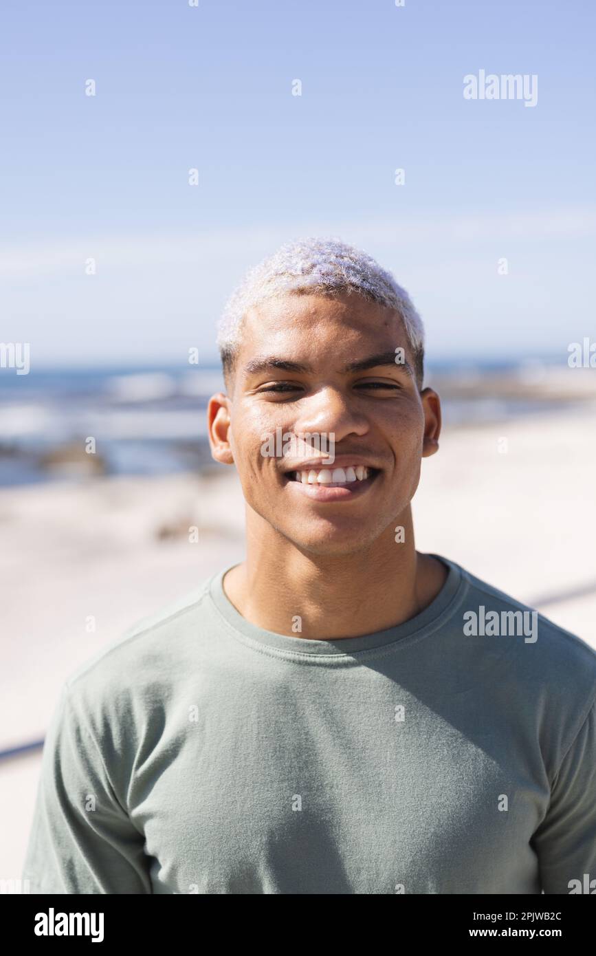 Portrait of happy biracial man looking at camera and smiling at beach Stock Photo - Alamy