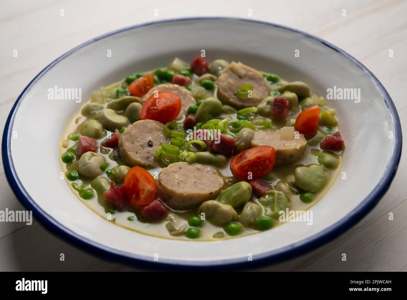 Bean stew with ham and black pudding. Traditional Spanish tapa recipe ...