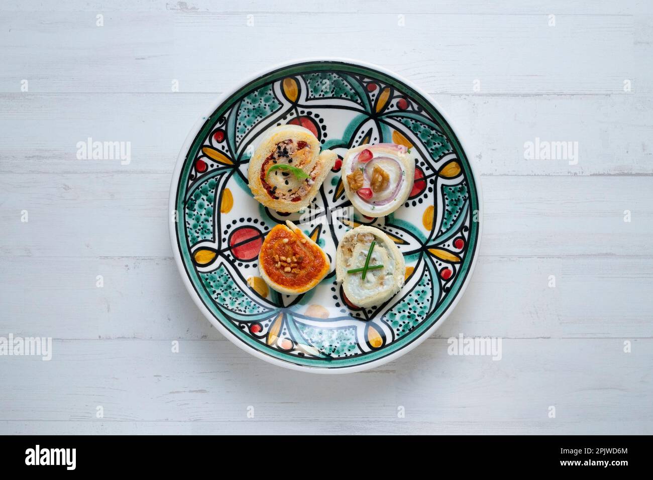 Canapes made with sliced bread stuffed with cheese, nuts, sobrassada ...