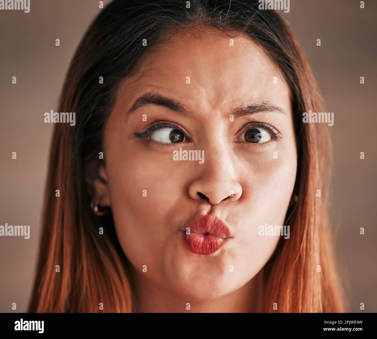 Funny face, goofy and woman with emoji, silly and humor against a brown ...