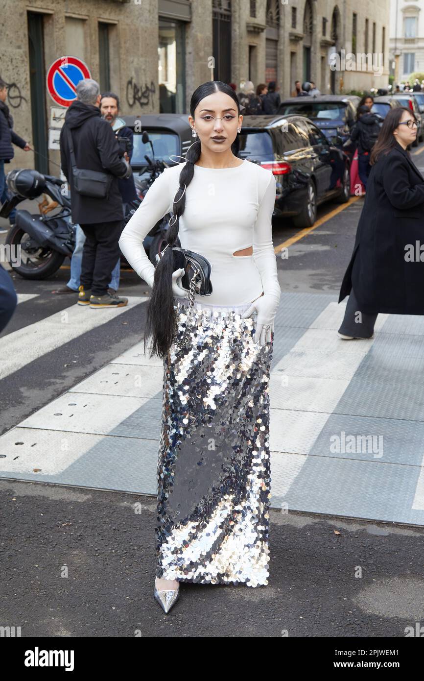 MILAN, ITALY - FEBRUARY 25, 2023: Woman with white shirt and silver ...