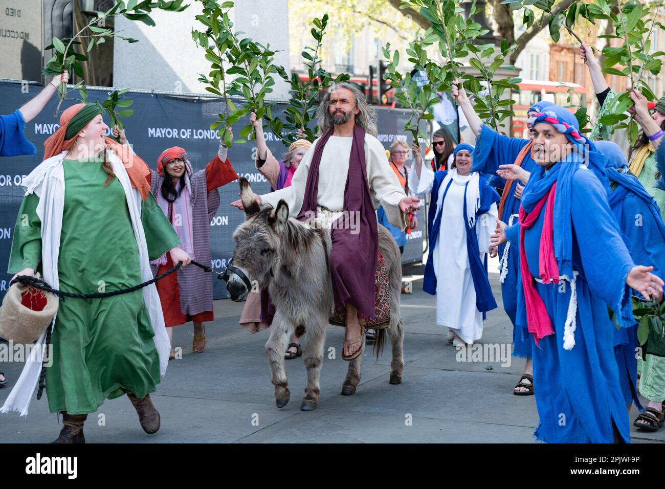 Jesus arrives on a donkey and is greeted by his disciples during a re ...