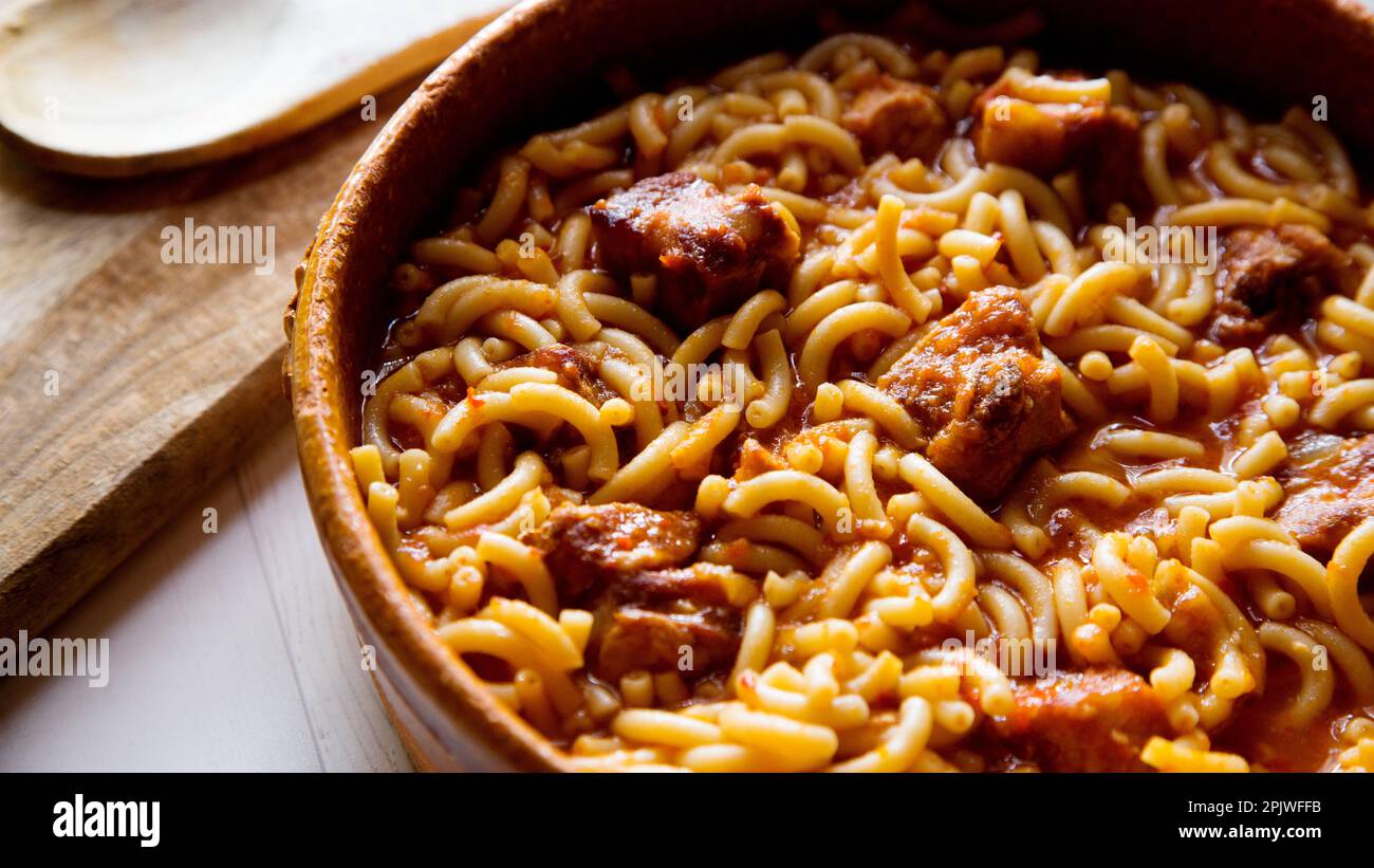 Casserole noodles with pork rib. Traditional Spanish tapa recipe cooked ...