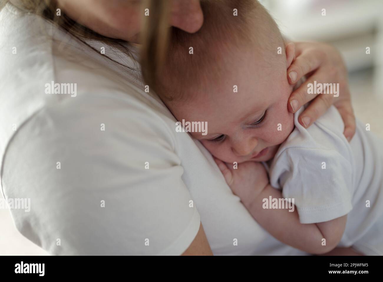 Loving and affectionate mother holding newborn baby Stock Photo - Alamy