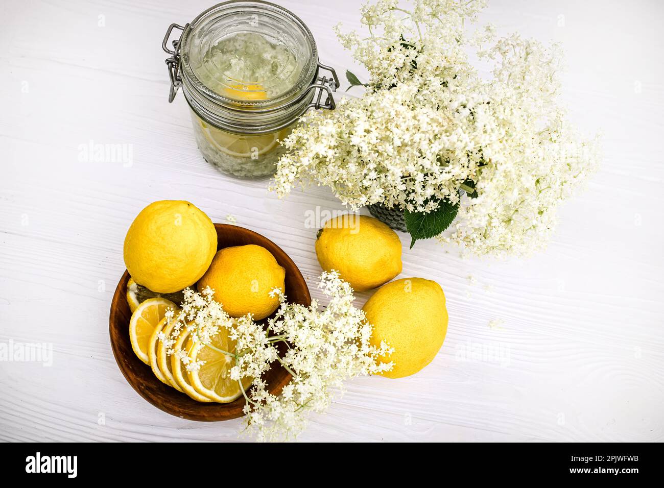 wooden plate with fresh lemons for a healthy refreshing non-alcoholic ...