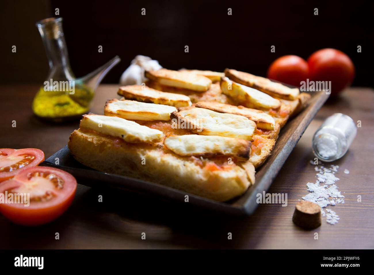 Baked halloumi cheese served with toasts Stock Photo - Alamy