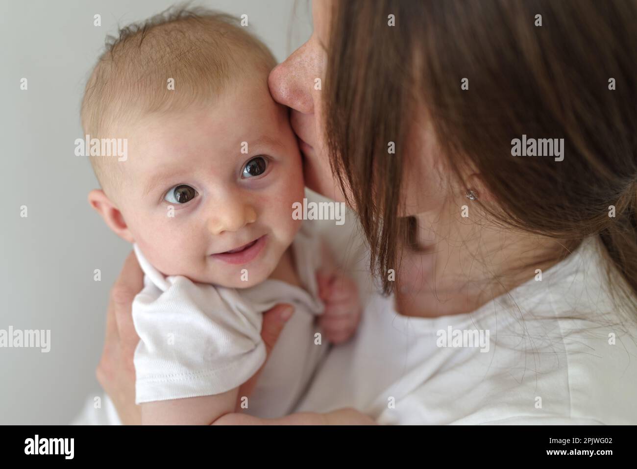 Loving and affectionate mother holding newborn baby Stock Photo - Alamy