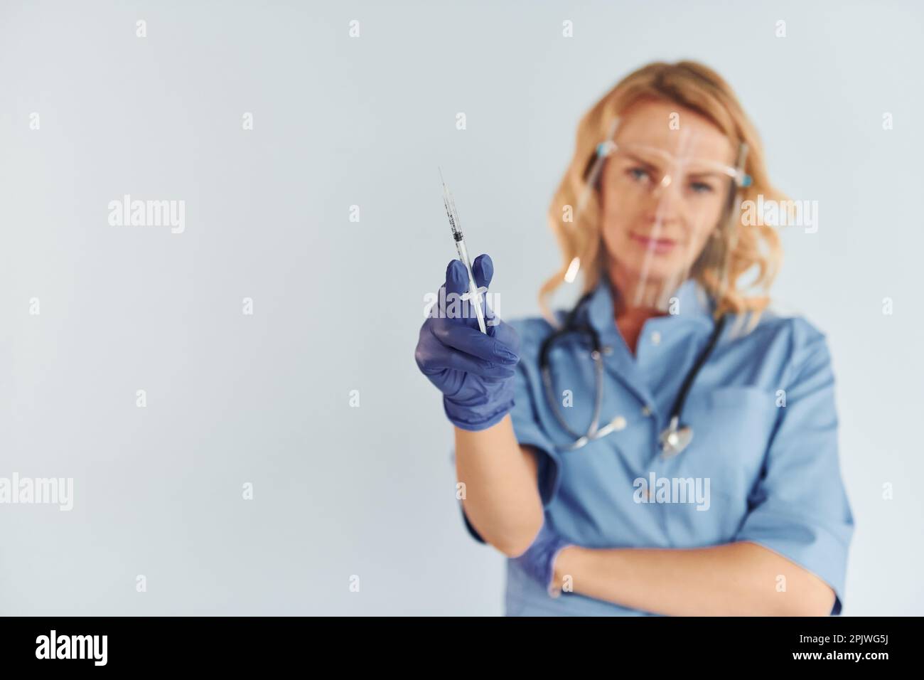 Professional occupation. Young female doctor in uniform is indoors ...