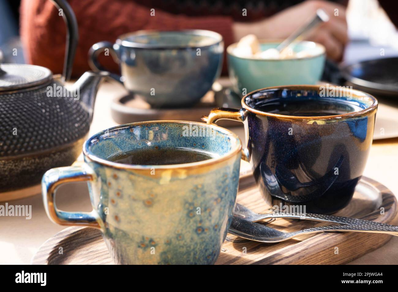 Brewing and Serving Tea. Teapot Poured Green Tea Blue Ceramic Cup on ...