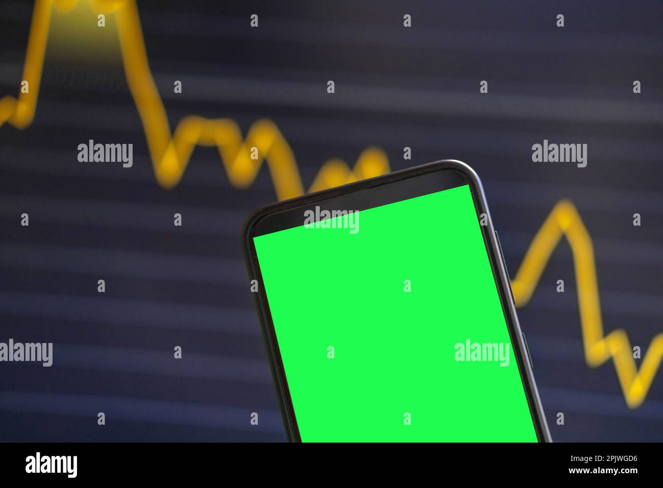 Black phone with blank mockup screen on rising stock graph. Closeup ...