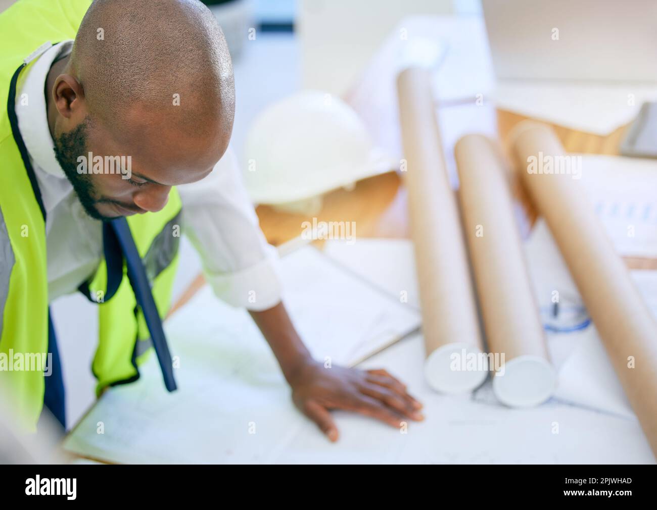Blueprint, architect and black man in office with paper, design and ...