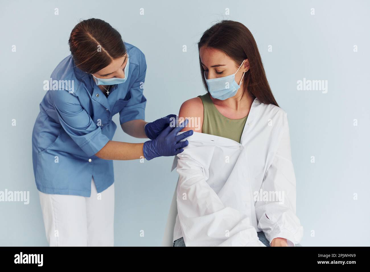 SImple but effective procedure. Doctor in uniform making vaccination to ...
