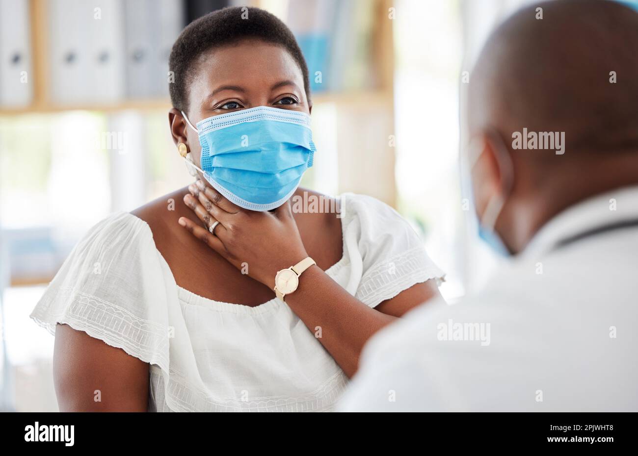 Black woman, sore throat and face mask, doctor and patient in hospital ...