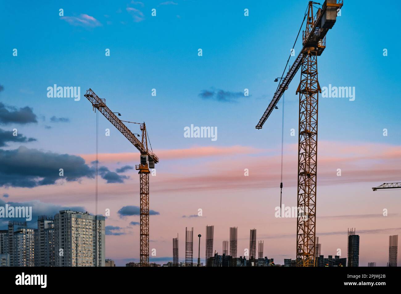 Large construction site with cranes working on a building complex, with ...
