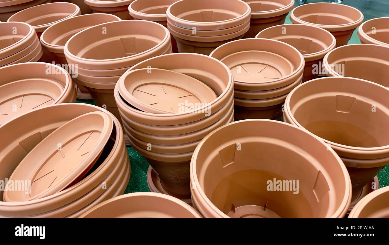 Close-up of empty flower pots in a store or greenhouse. Colorful pots ...