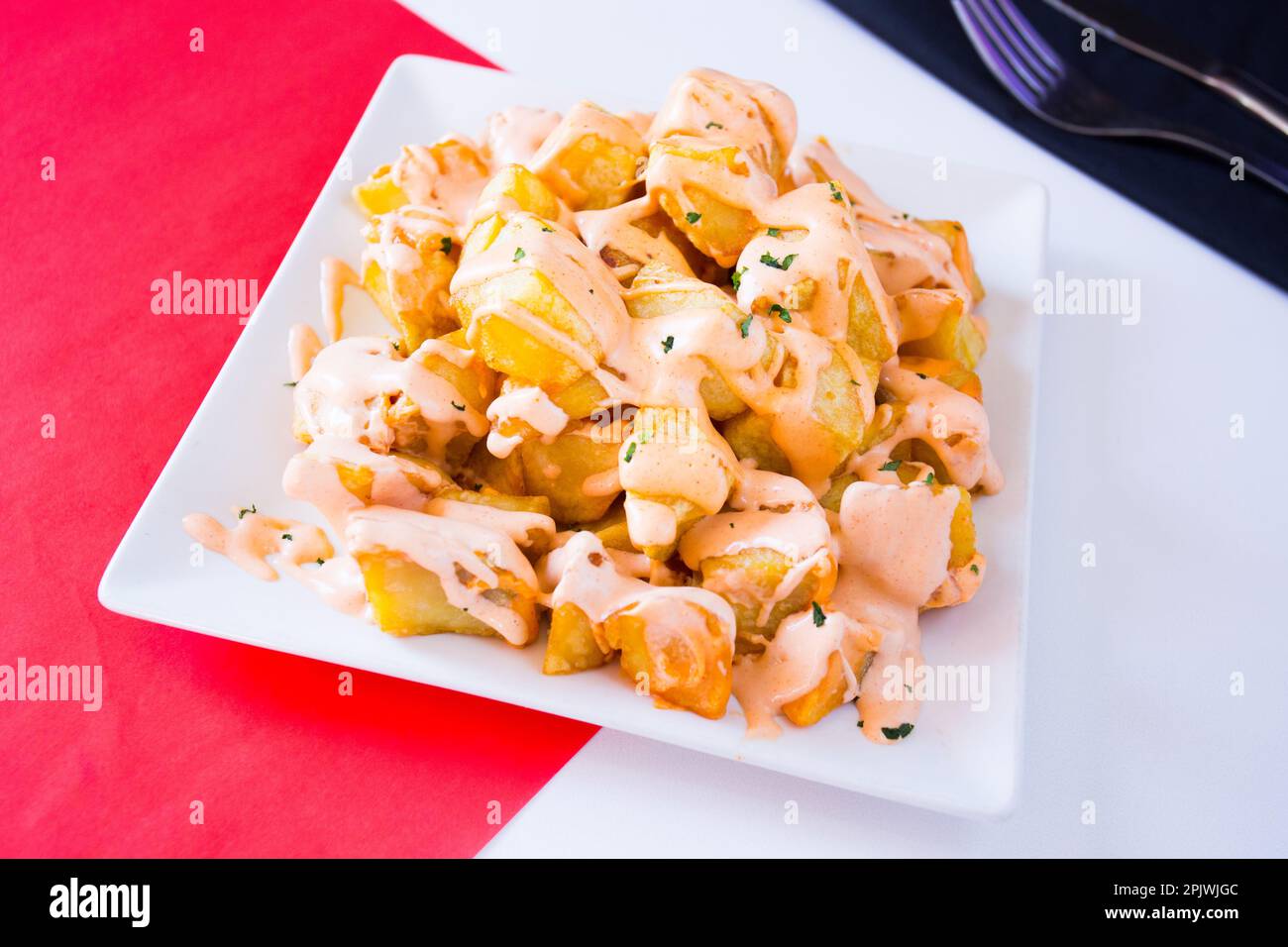 Papas bravas, are a typical preparation of bars in Spain consisting of ...