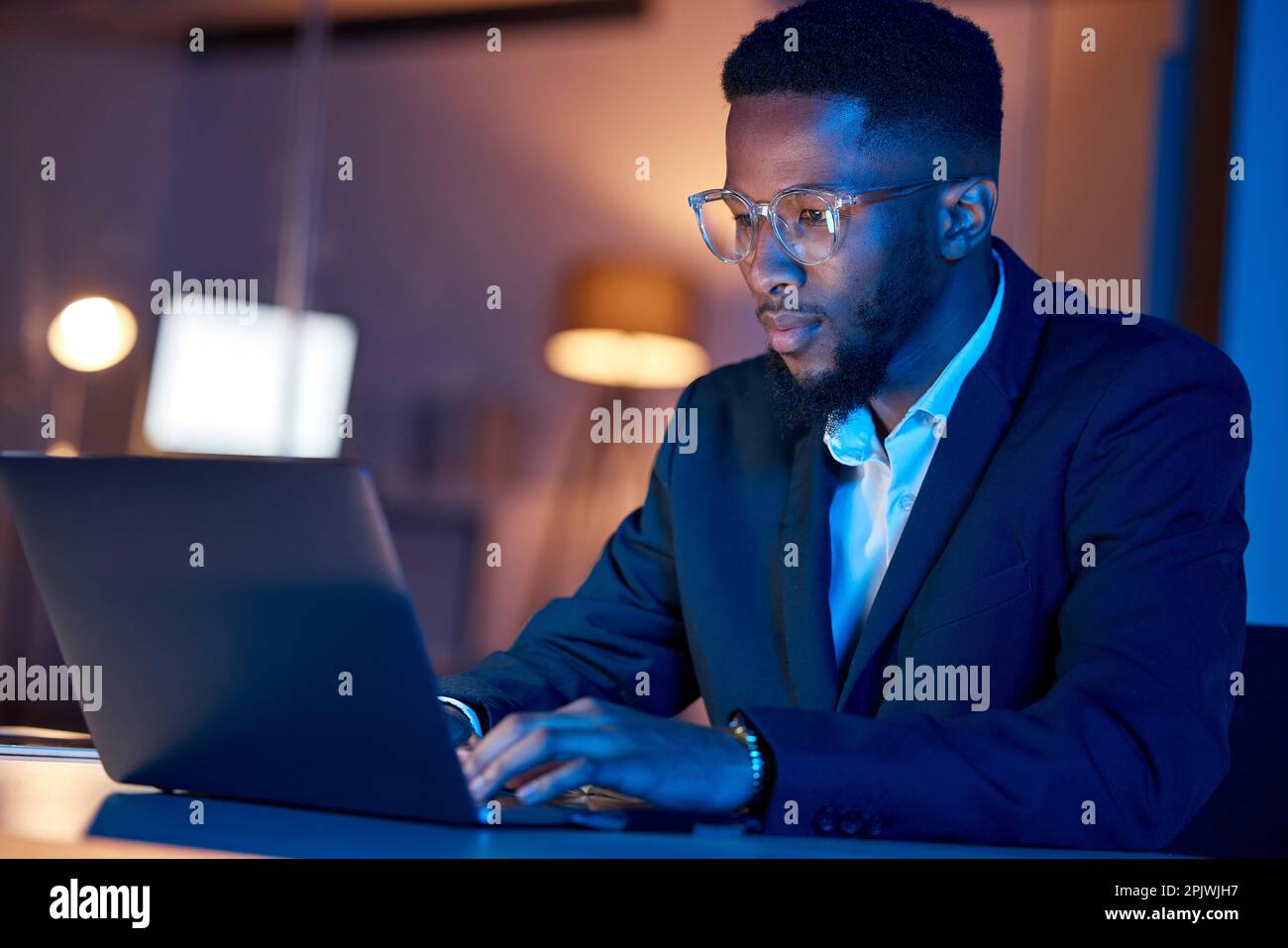 Black man, laptop and typing, businessman focus with coding or writing ...