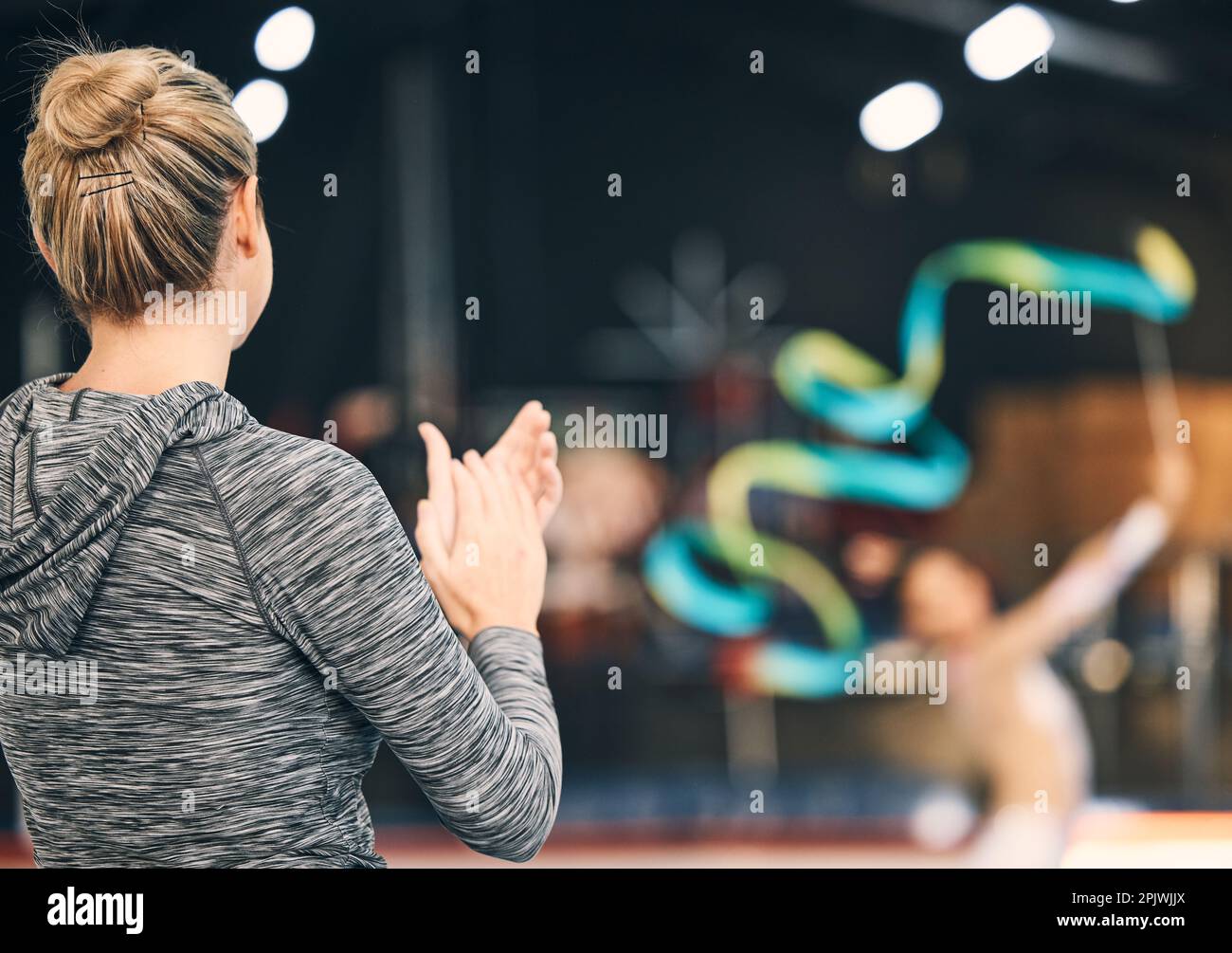 Coaching, gymnastics and clapping with woman in stadium for training ...