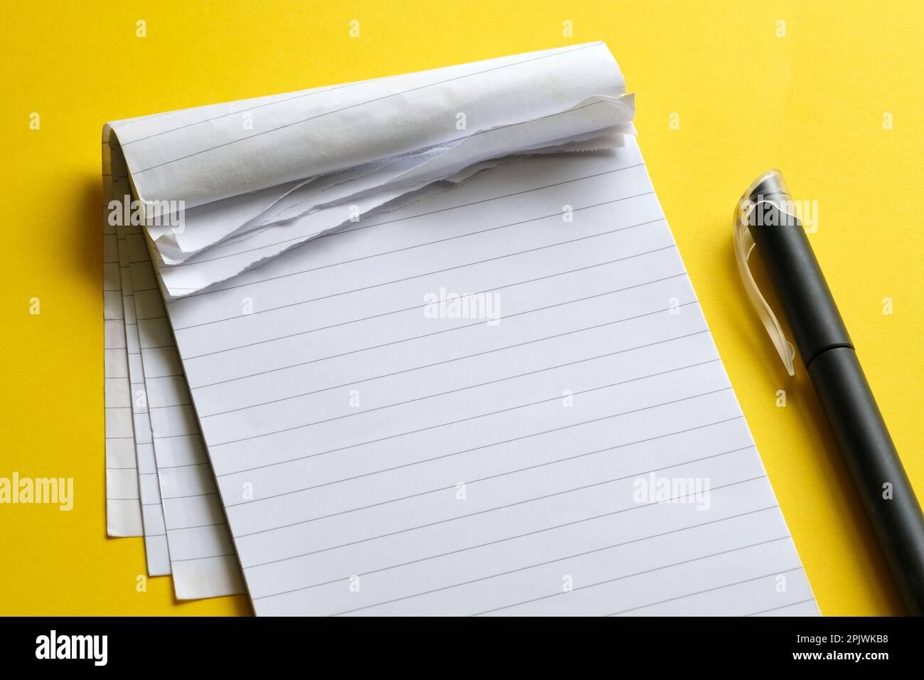 Top view of blank open notebook with torn pages. Page with lines and ...