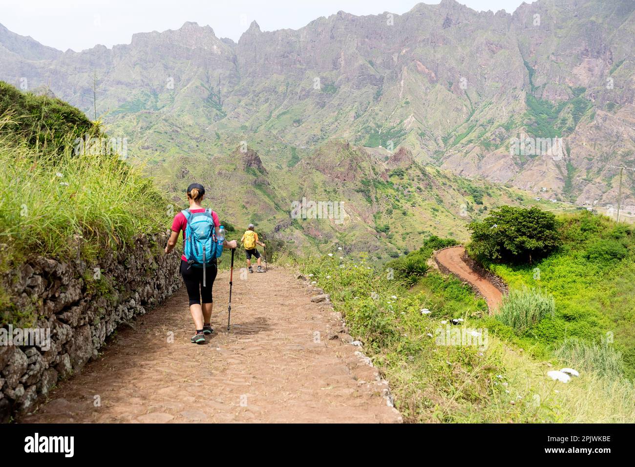 Mother and son, tourists, on a beautiful hiking trail in the mountains ...