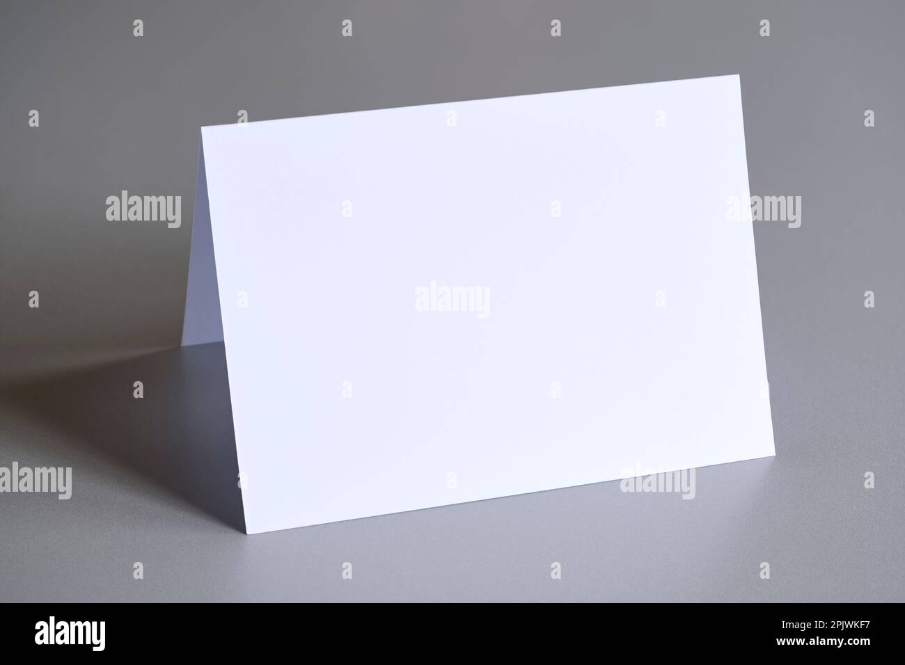 Standing blank empty rectangular greeting card mock up on clean cool ...