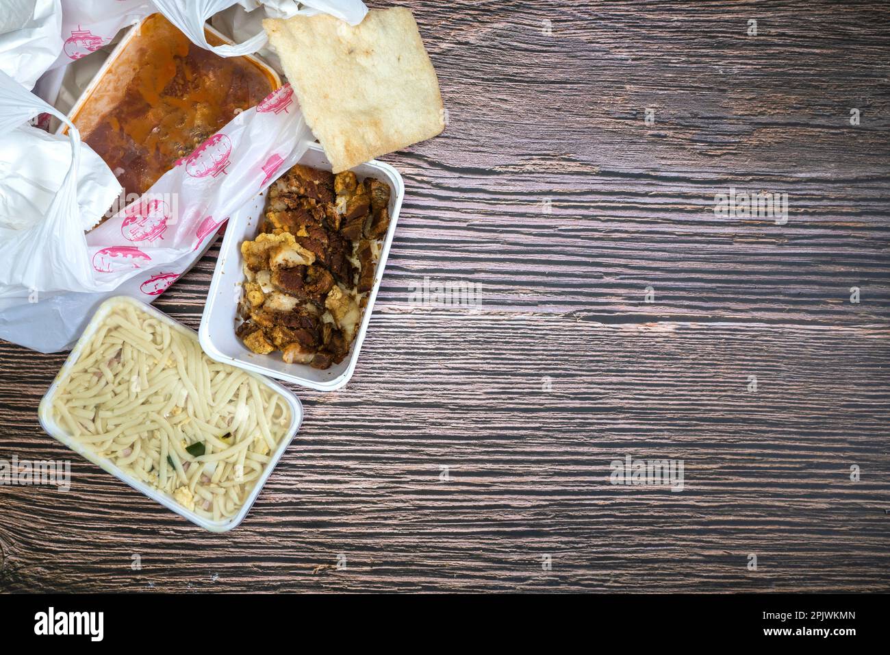 Chinese takeaway food selection in plastic bag. Bami, babi pangang ...